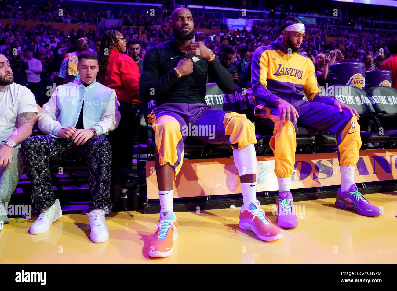 Los Angeles Lakers forwards LeBron James, left, and Anthony Davis sit on the bench before an NBA ...