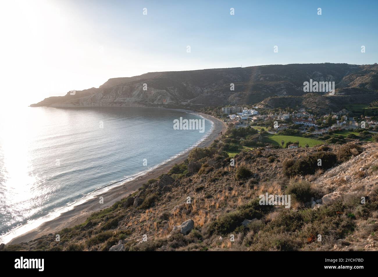 Sun shining on the Mediterranean sea and the village of Pissouri, in ...