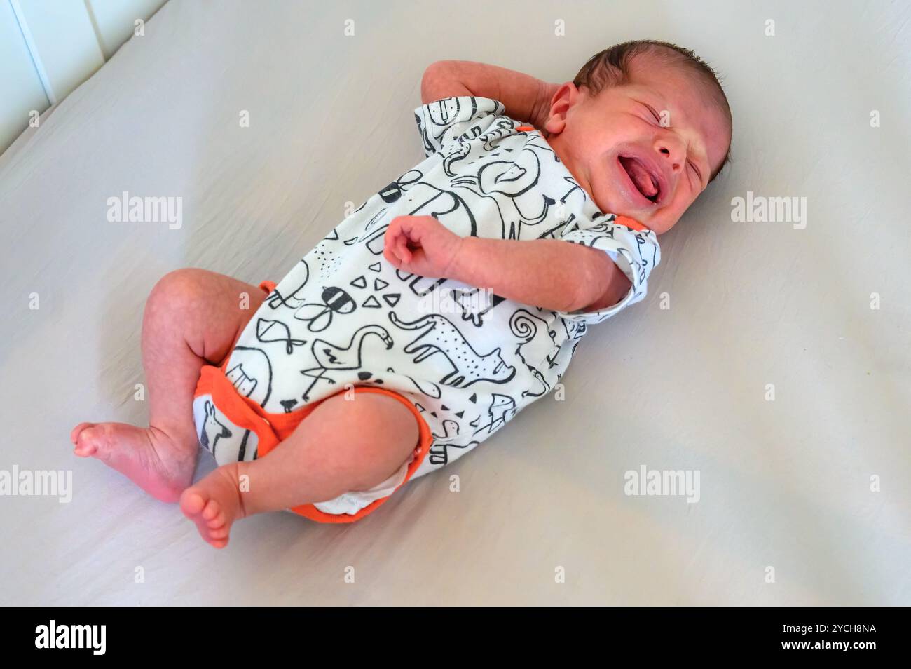 A baby boy wakes up and starts crying for attention Stock Photo - Alamy