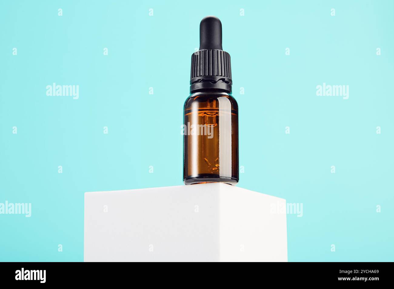 Glass dropper container is on white shape on blue Stock Photo - Alamy