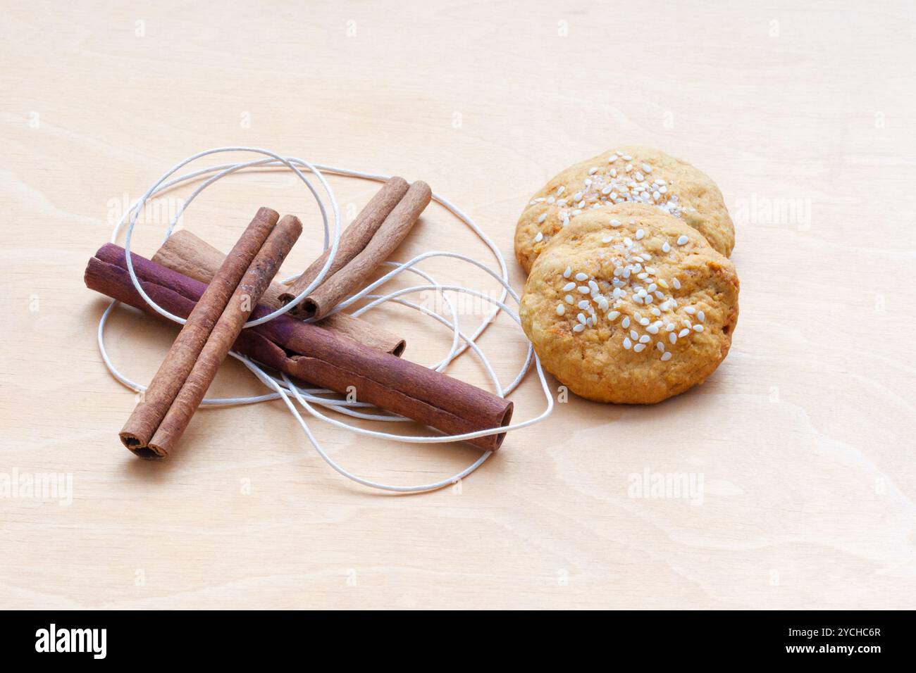 Biscuits, cinnamon sticks and a cord Stock Photo - Alamy