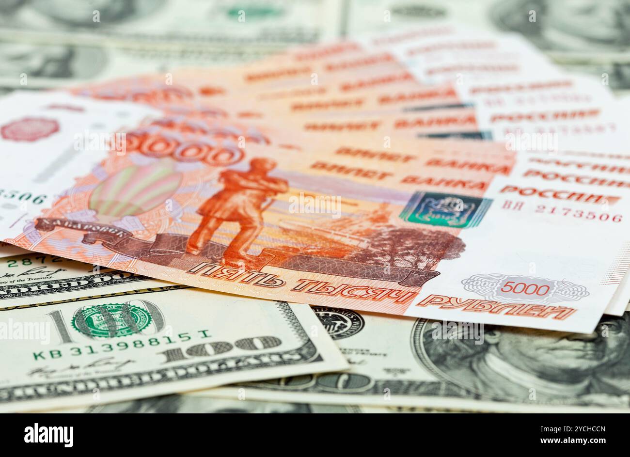 Russian roubles bills laying over dollars background Stock Photo - Alamy