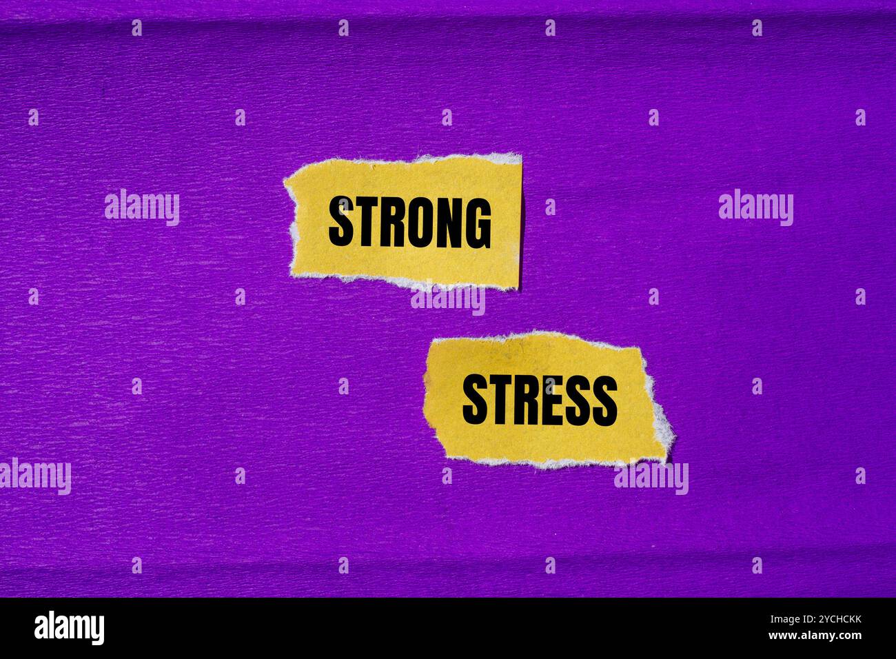 Strong stress message written on ripped torn yellow paper pieces with ...
