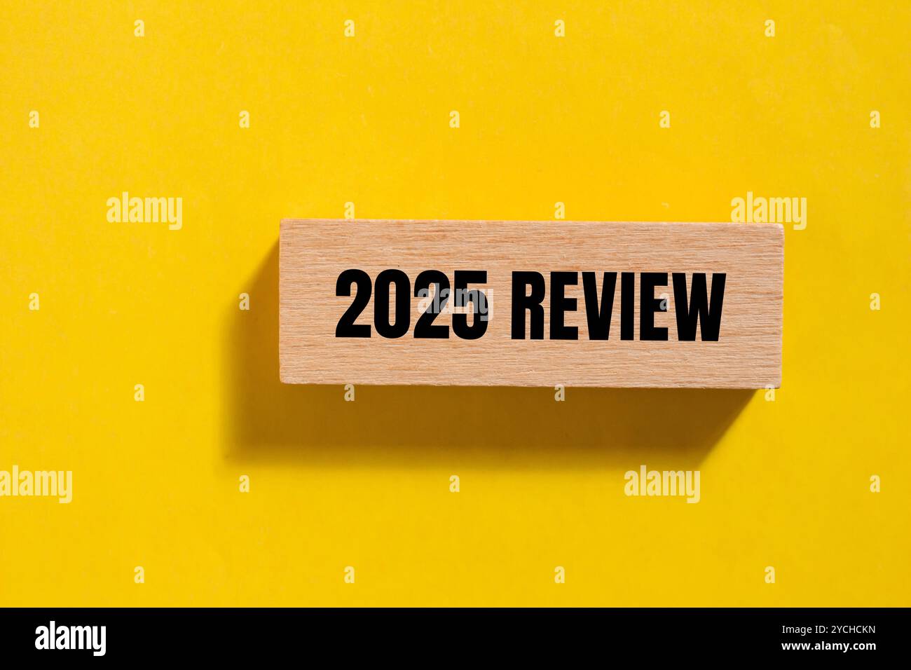 2025 review message written on wooden block with yellow background. Conceptual 2025 review ...