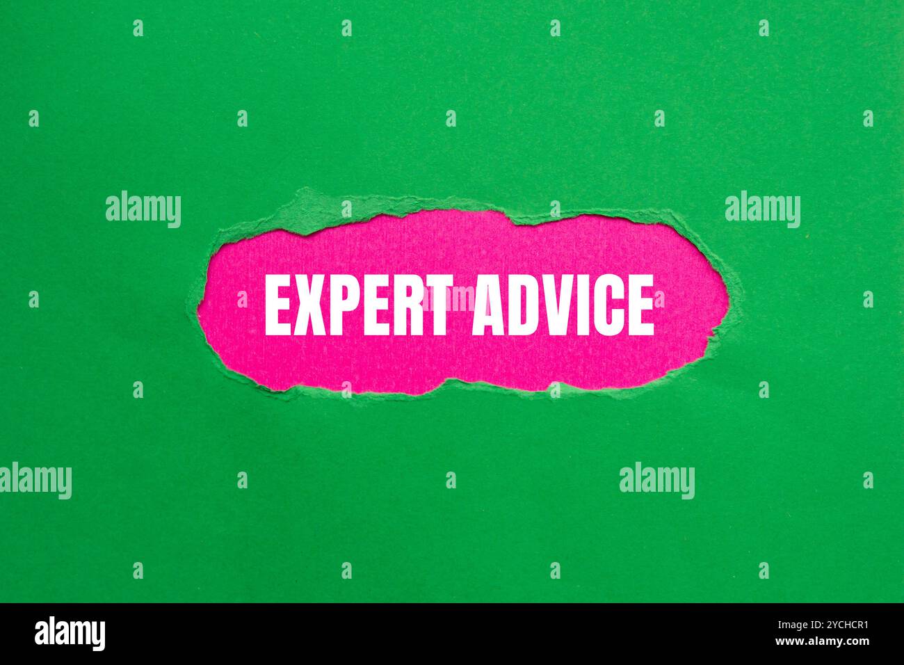 Expert advice message written on ripped torn green paper with pink background. Conceptual expert ...