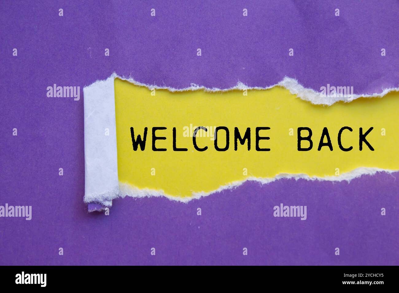 Welcome back message written on ripped torn purple paper with yellow ...