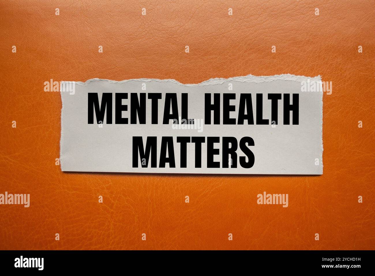 Mental health matters message written on ripped torn paper piece with brown background ...