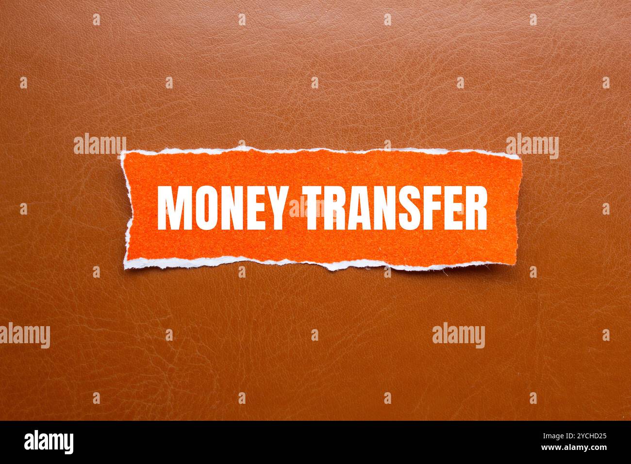 Money transfer message written on ripped torn orange paper piece with brown background ...