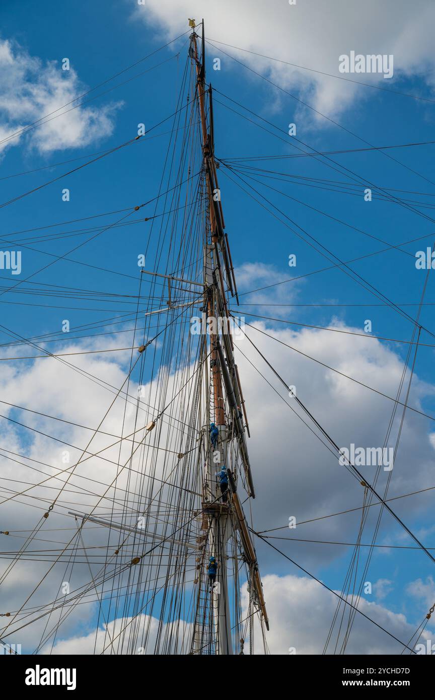 Climbers scaling the mast rigging on the Cutty Sark tea clipper museum ...