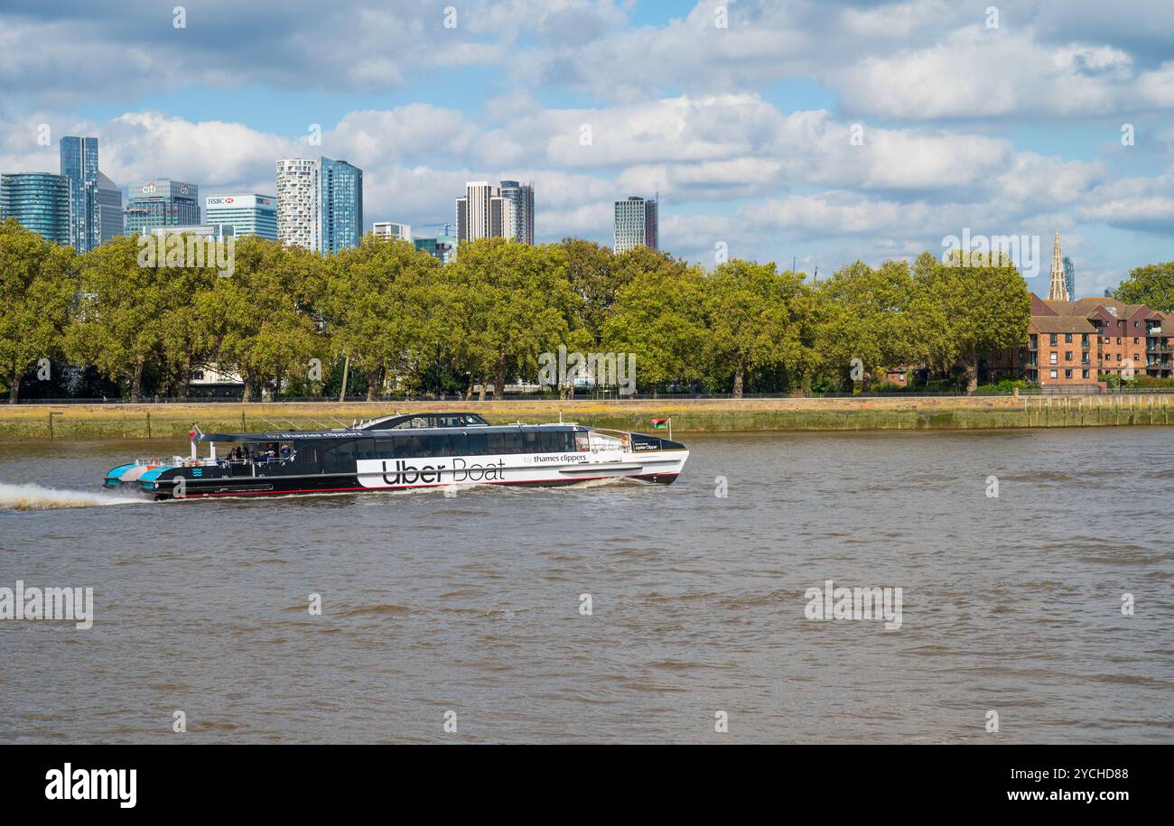 Uber Boat Thames Clipper riverboat moving along River Thames Greenwich ...