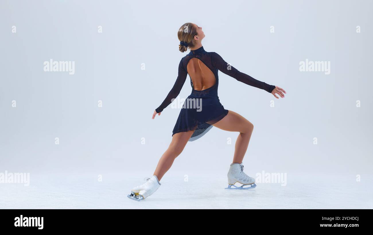 Young girl, figure skater in motion, in stunning move, performing ...