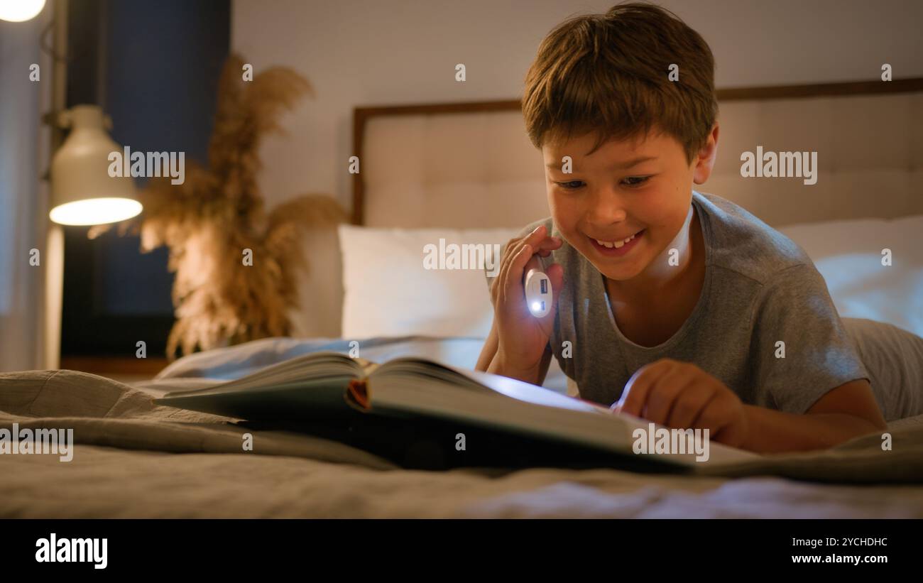Smiling happy little cute caucasian child kid boy schoolboy reading ...