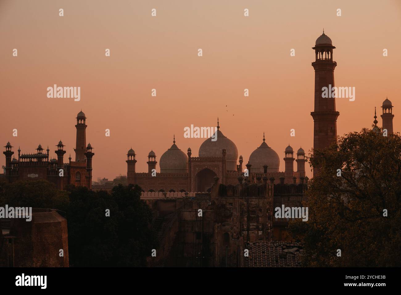 The stunning silhouette of Lahore’s Badshahi Mosque at sunset, capturing the grandeur and ...