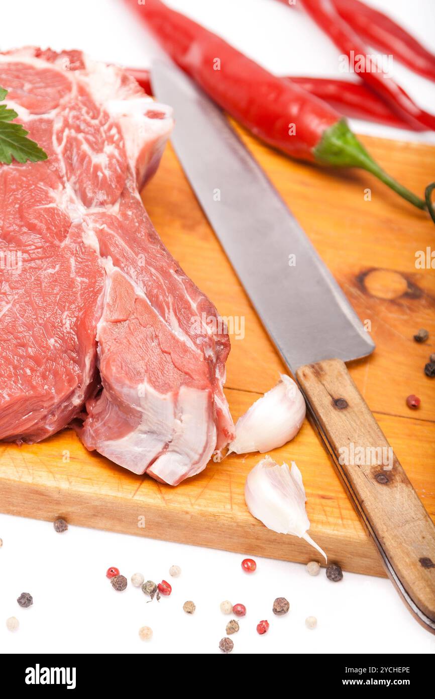 Fresh meat of beef with bone on wooden spices and knife Stock Photo - Alamy