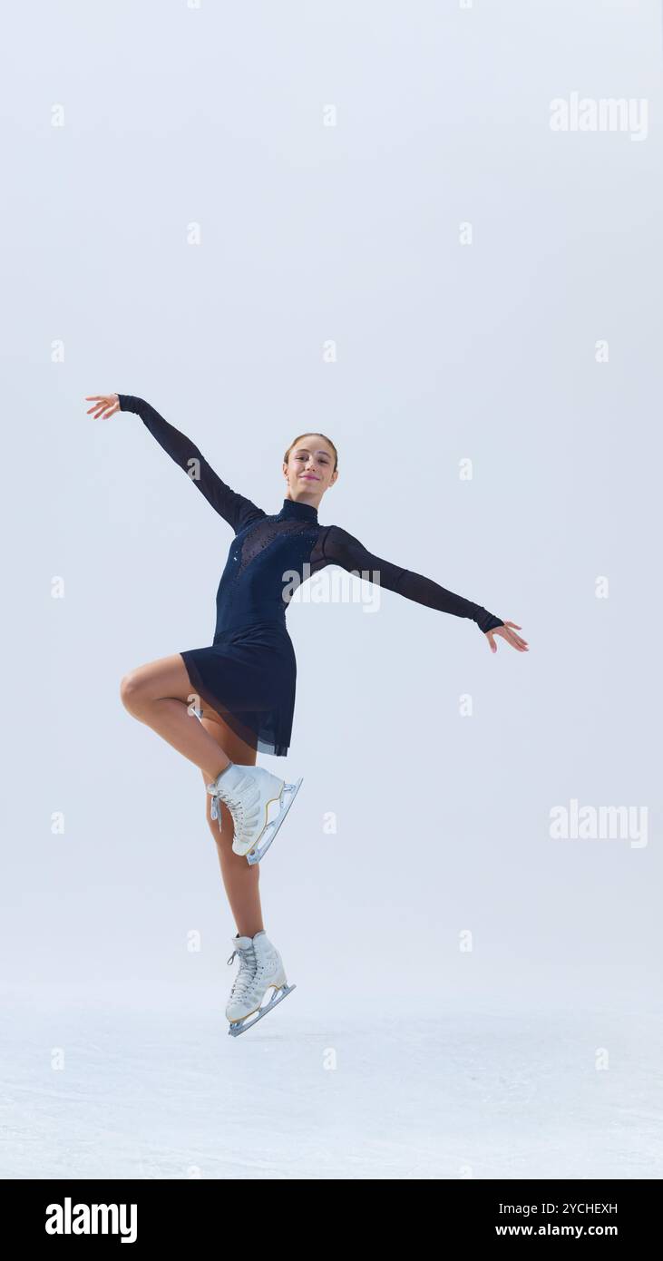 Vertical image. Beautiful and talented young girl, figure skater in ...