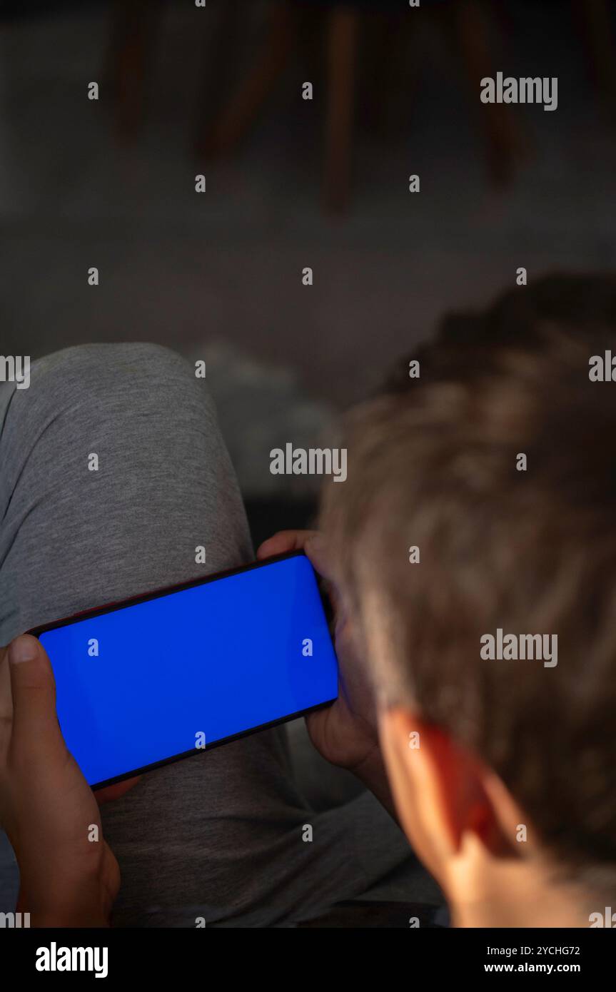 Child looking at phone screen. focus on phone. view from back Stock ...