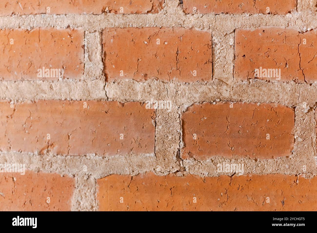 A brick wall with a white line in the middle. The wall is made of red ...