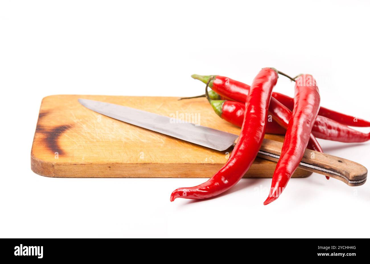 Hot capsicum chili pepper and knife on board Stock Photo - Alamy