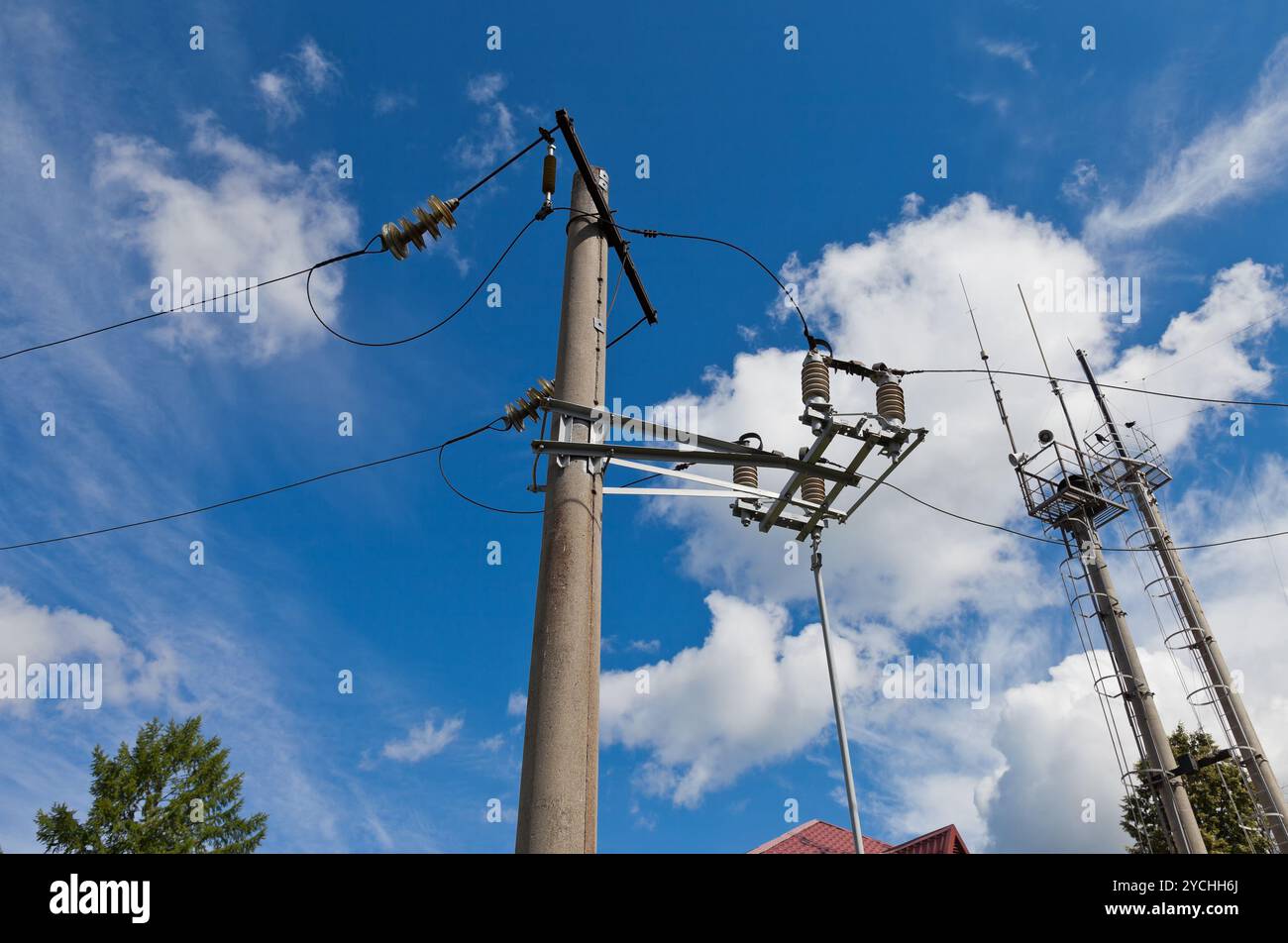 Electric power post with wire against bright blue sky and clouds Stock ...