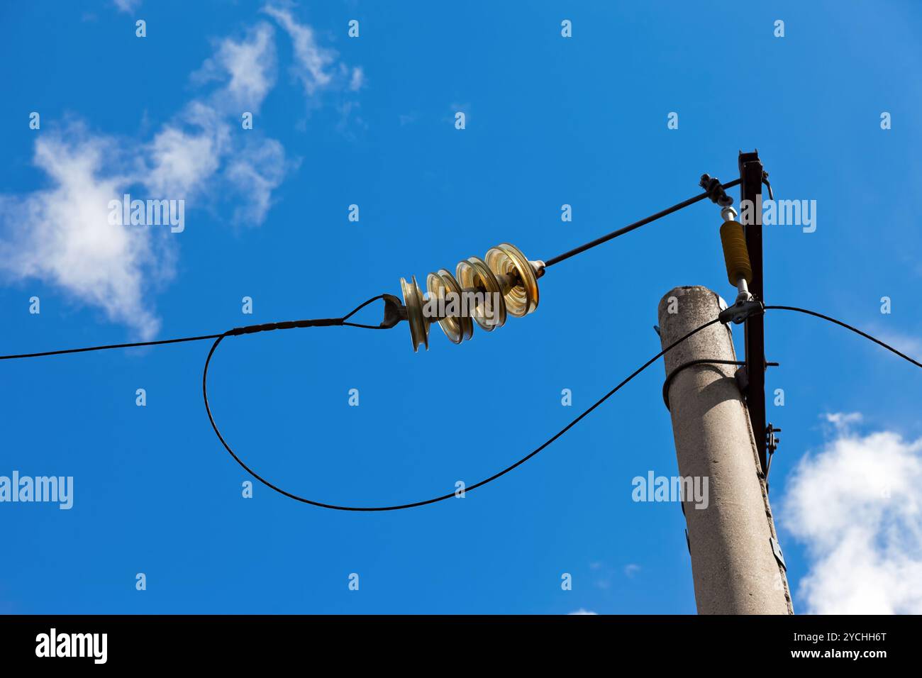 Electric power post with wire against bright blue sky and clouds Stock ...