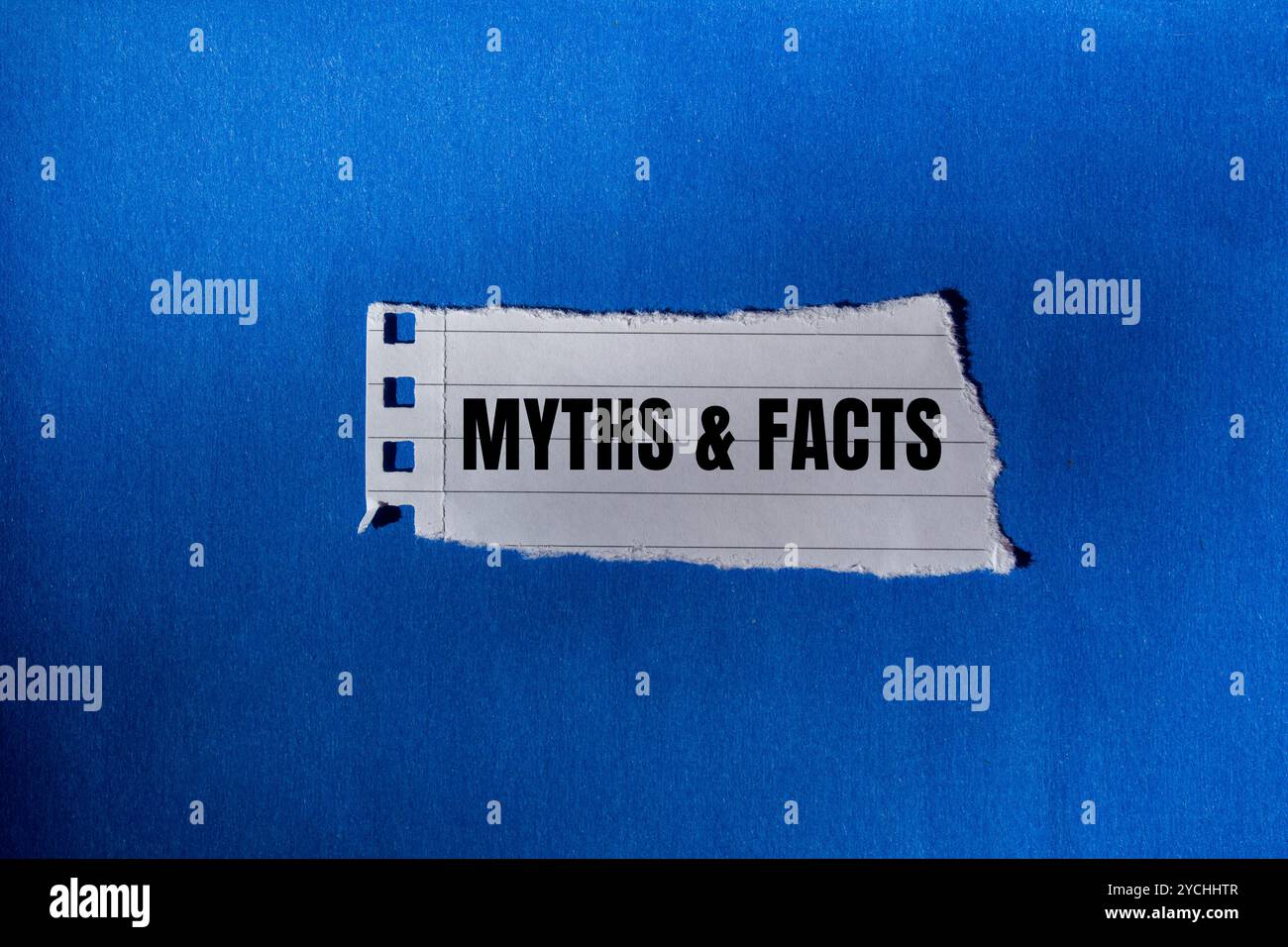 Myths and facts message written on ripped torn paper piece with blue ...