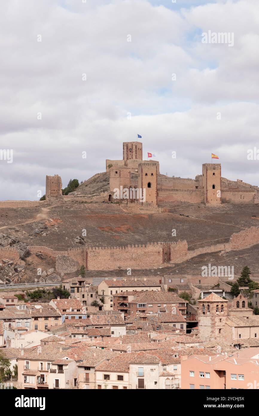 Historic castle atop a hill overlooking a traditional Spanish village ...