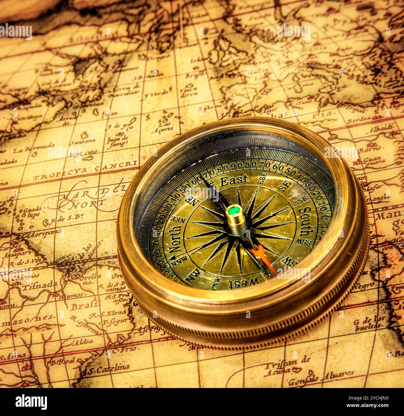 Vintage compass lies on an ancient world map Stock Photo - Alamy