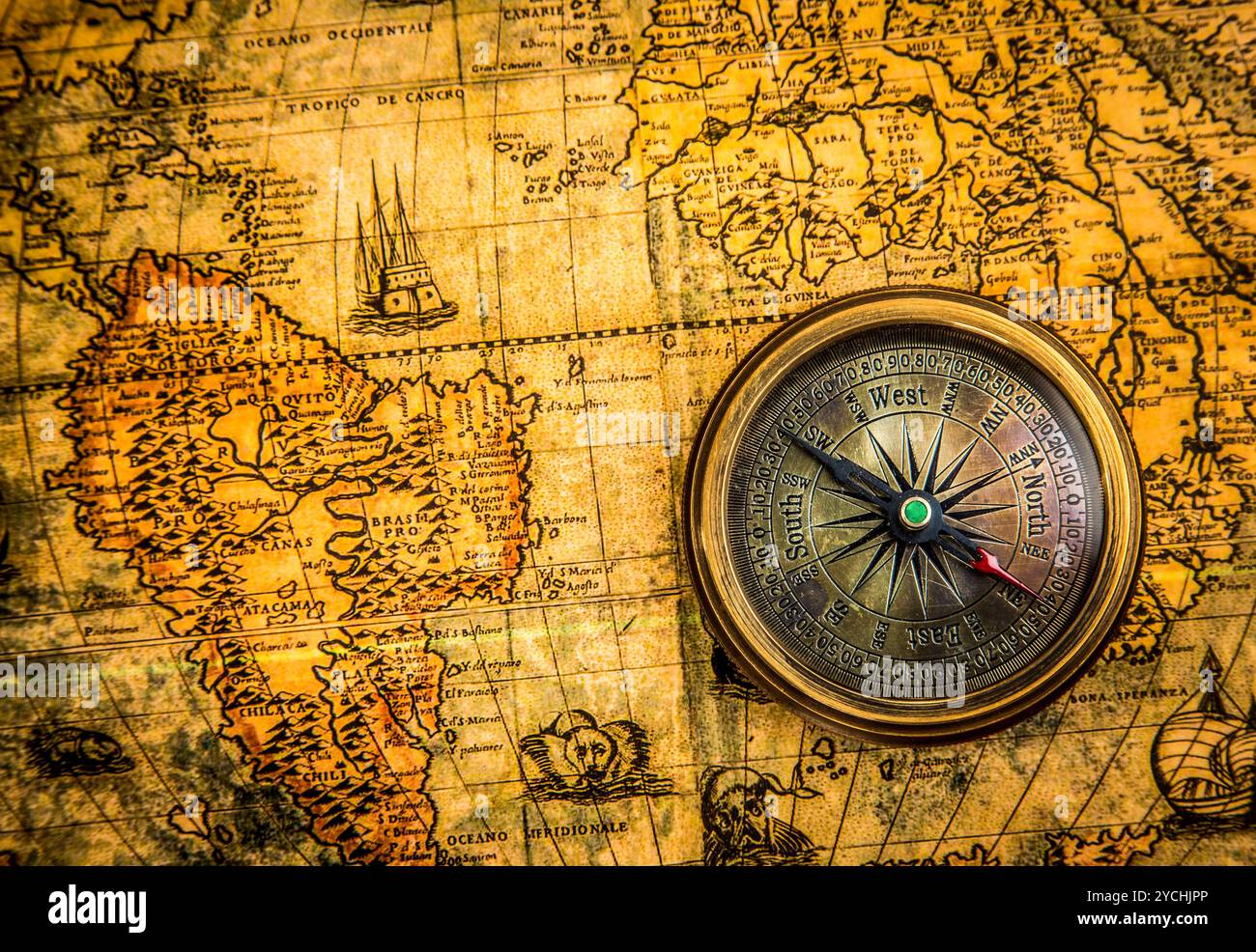 Vintage compass lies on an ancient world map Stock Photo - Alamy