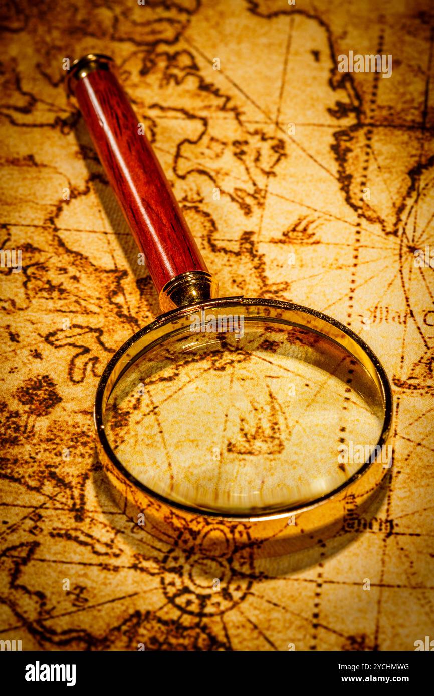 Vintage magnifying glass lies on an ancient world map Stock Photo - Alamy