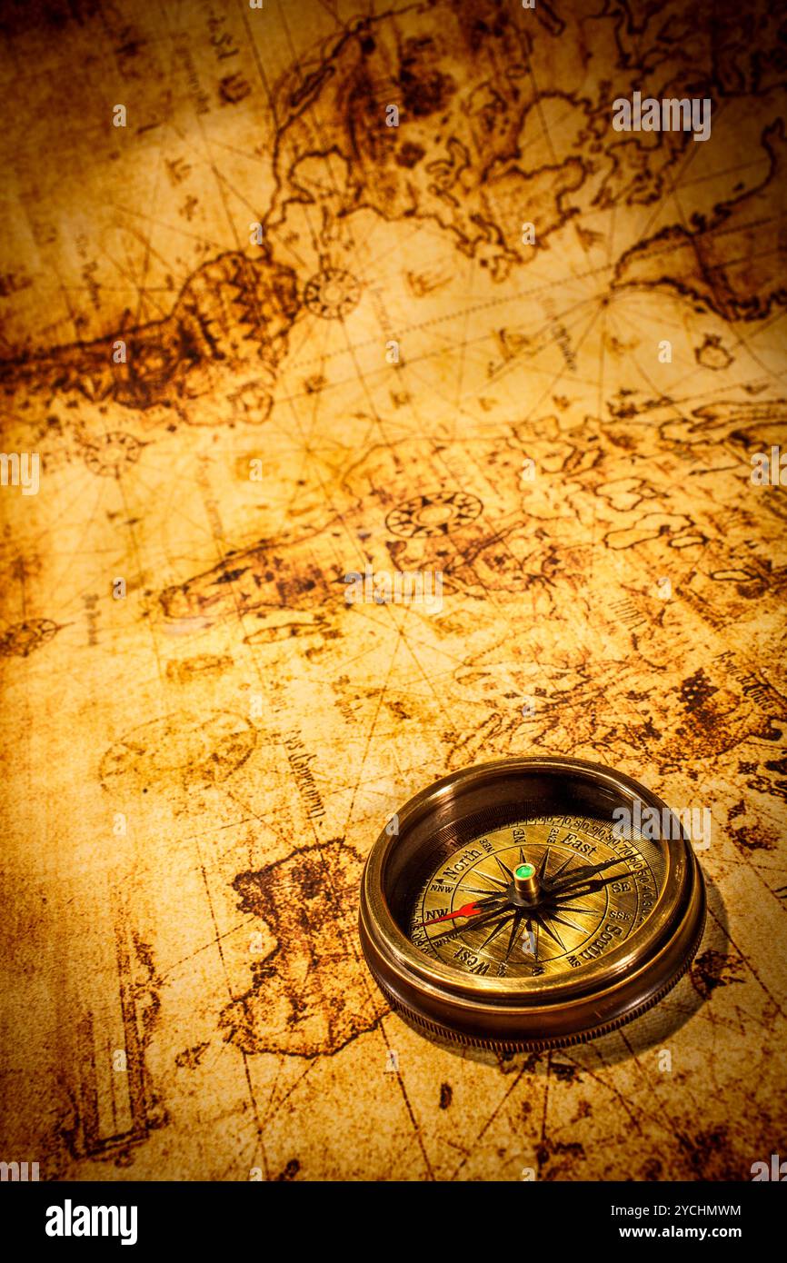 Vintage compass lies on an ancient world map Stock Photo - Alamy