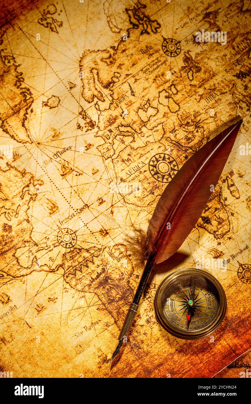 Vintage compass and goose quill pen lying on an old map Stock Photo - Alamy