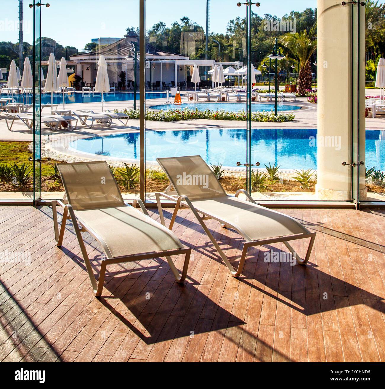 Sunbeds in the indoor swimming pool Stock Photo - Alamy