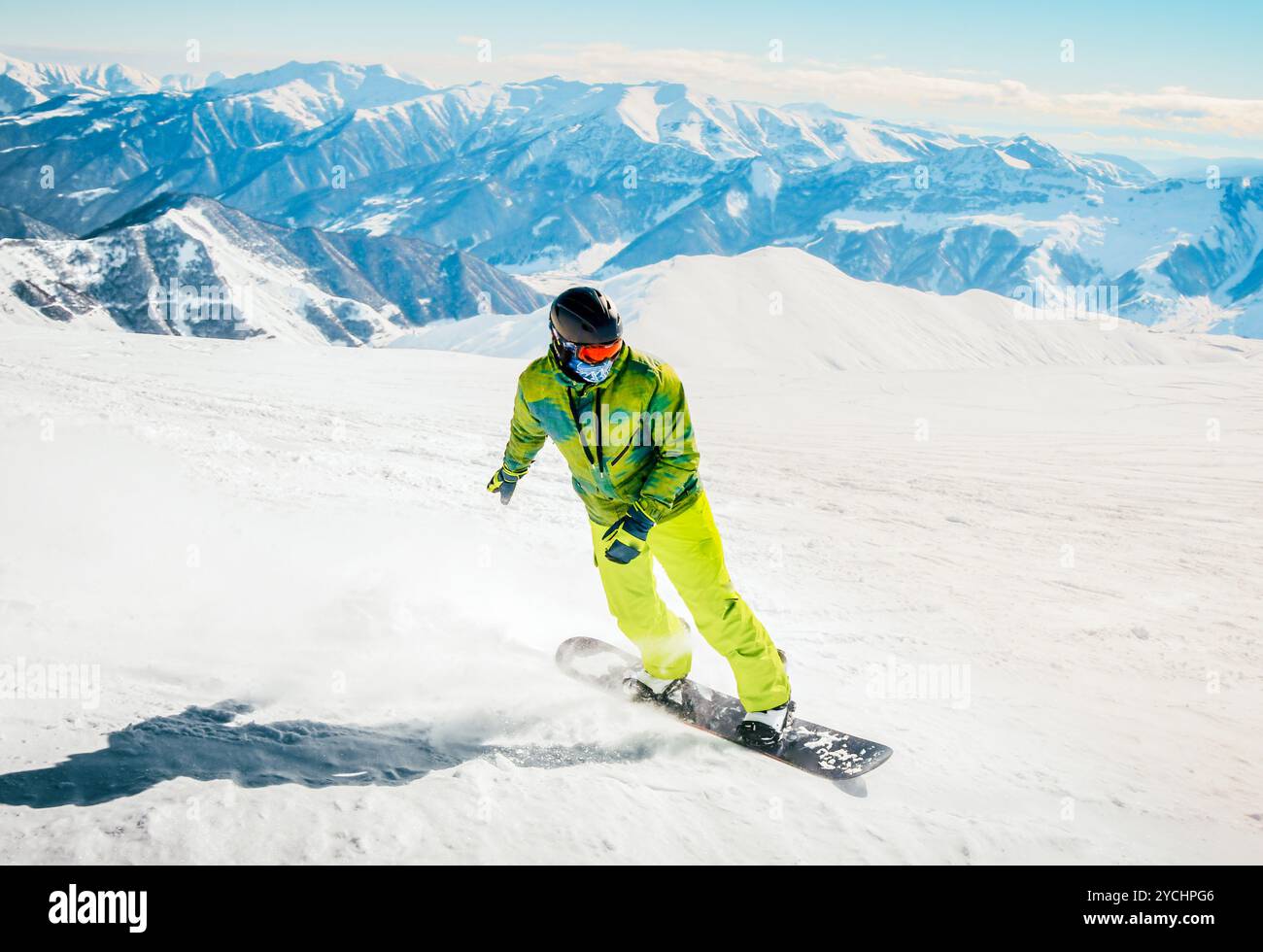 Snowboarder ride downhill motion freeze with mountains background. Free ...