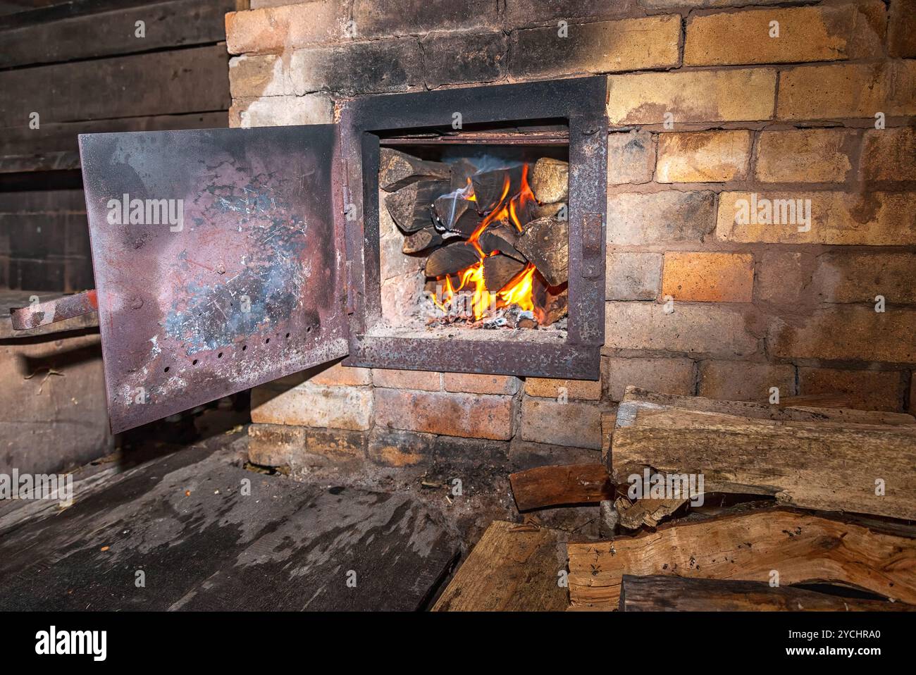 Old stove with open door and burning the wood Stock Photo - Alamy