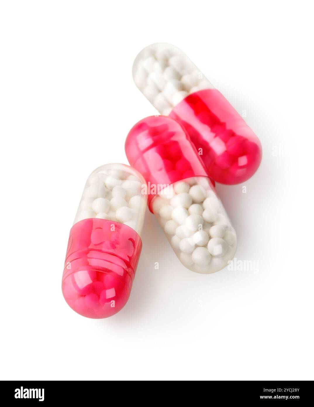 Three red capsules Stock Photo - Alamy