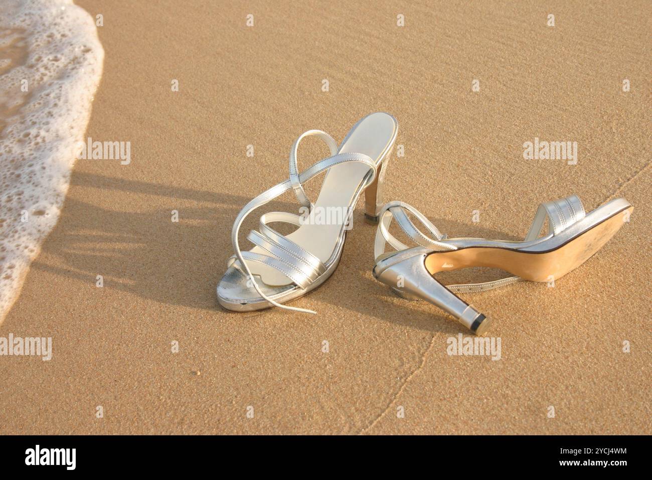 Ladies silver shoes on a beach Stock Photo - Alamy