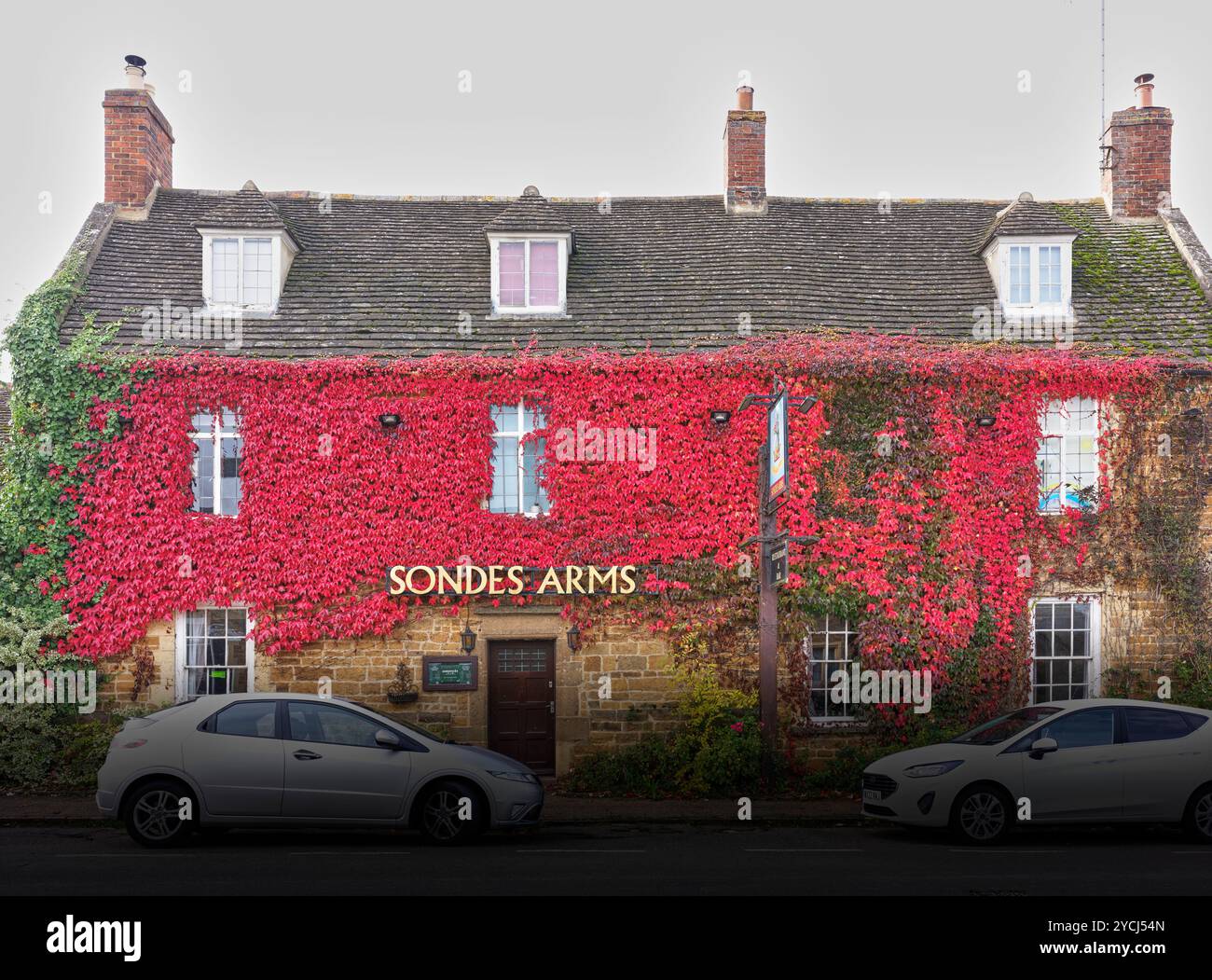 Red ivy on a wall of the Sondes Arms pub in the village of Rockingham ...