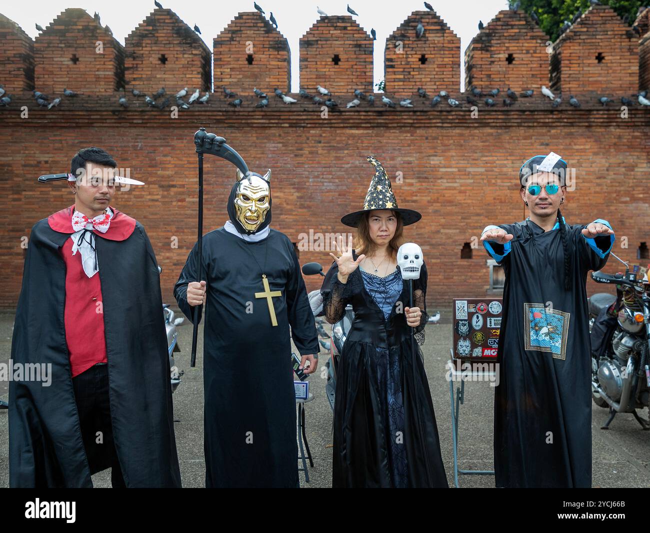 A barber dressed as Count Dracula, wearing a Grim Reaper mask, along ...