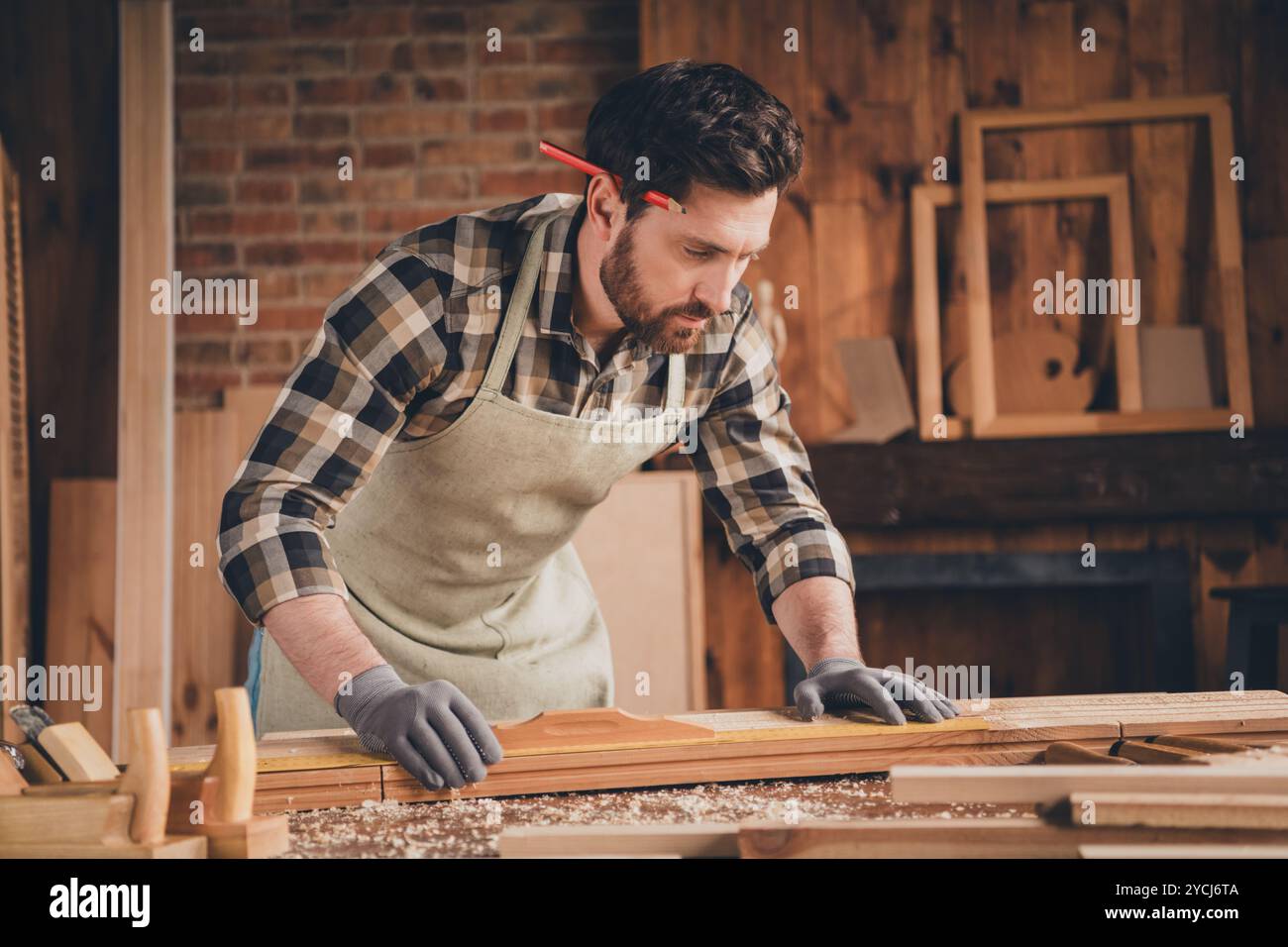 Photo of professional wood man worker using ruler for measuring plank ...