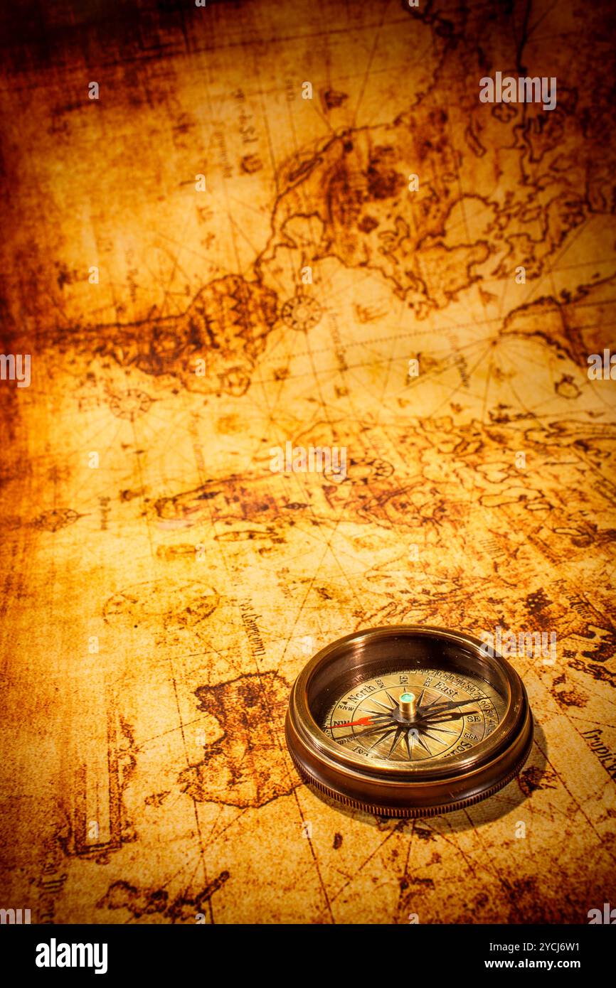 Vintage compass lies on an ancient world map Stock Photo - Alamy