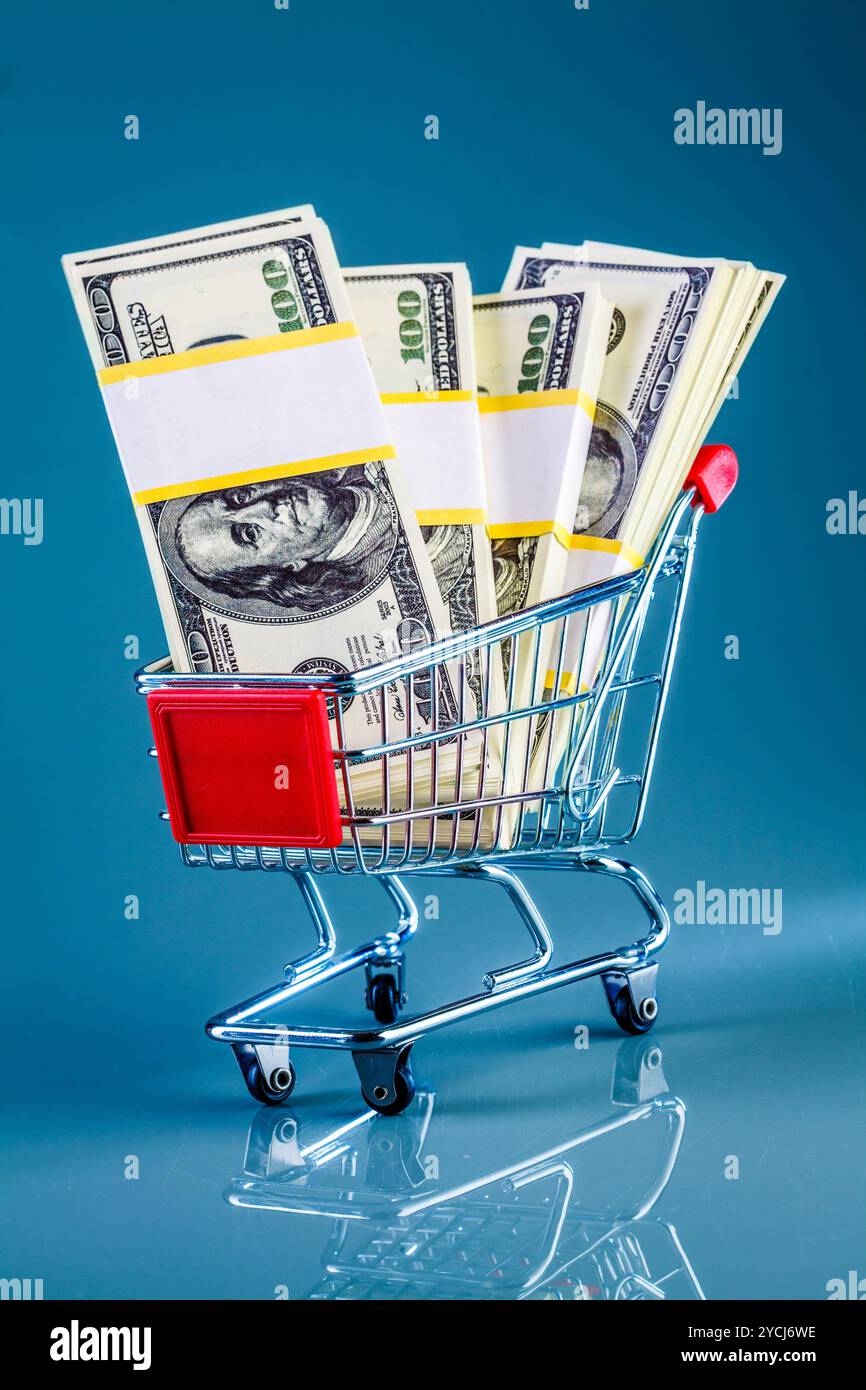 Shopping cart and money Stock Photo - Alamy