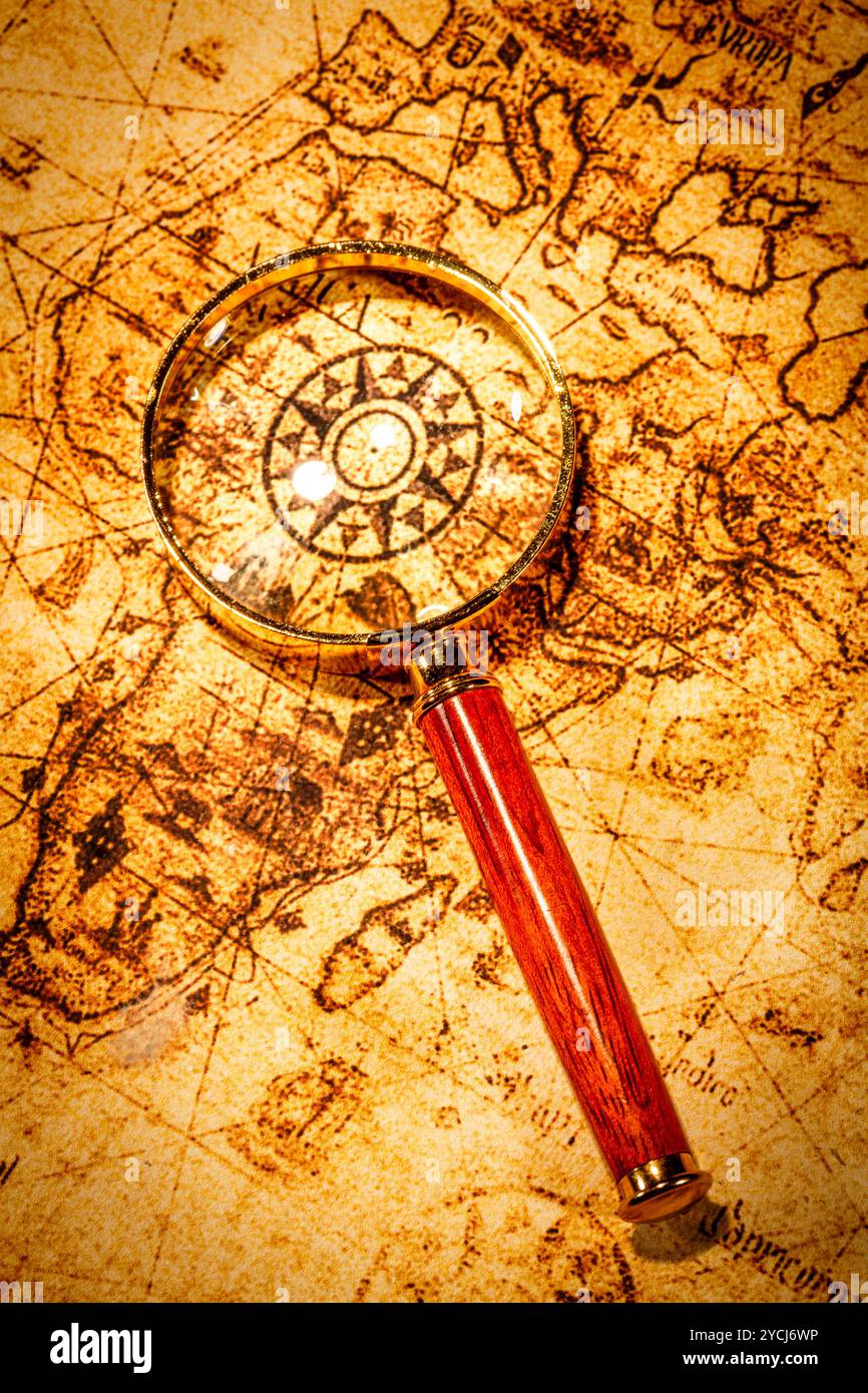 Vintage magnifying glass lies on an ancient world map Stock Photo - Alamy