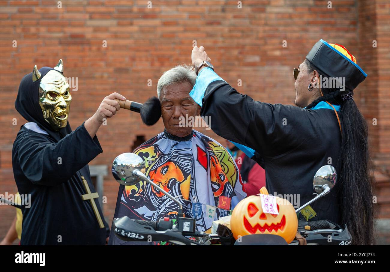 A barber dressed as a Chinese vampire, often known as a 'jiangshi,' and ...