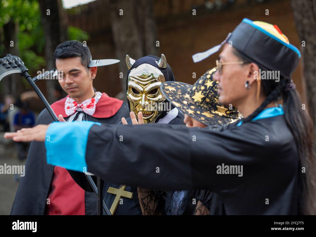 A barber wearing a Grim Reaper mask, seen next to a colleague dressed ...
