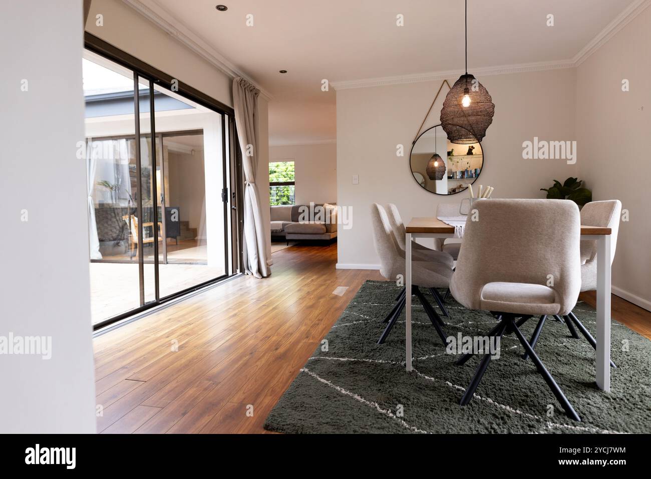 Modern dining room with elegant decor and cozy seating, sunlight ...