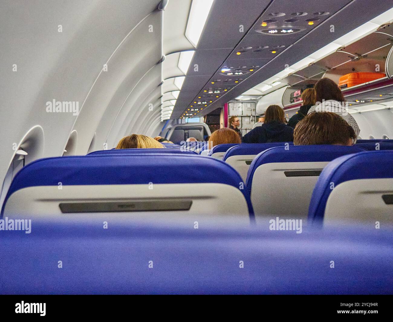 Interior of a modern airplane. Passengers inside the plane Stock Photo ...