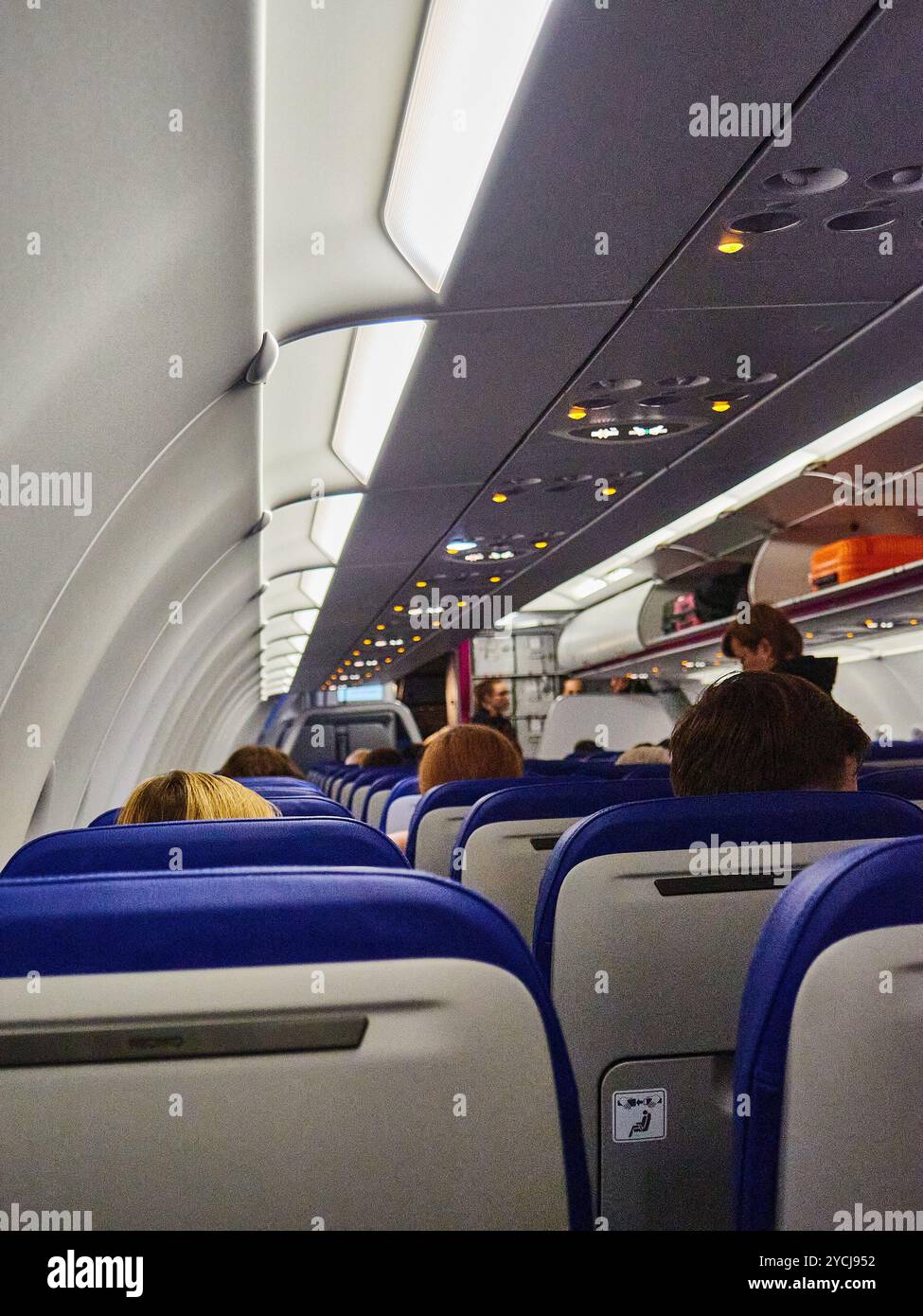 Interior of a modern airplane. Passengers inside the plane Stock Photo ...