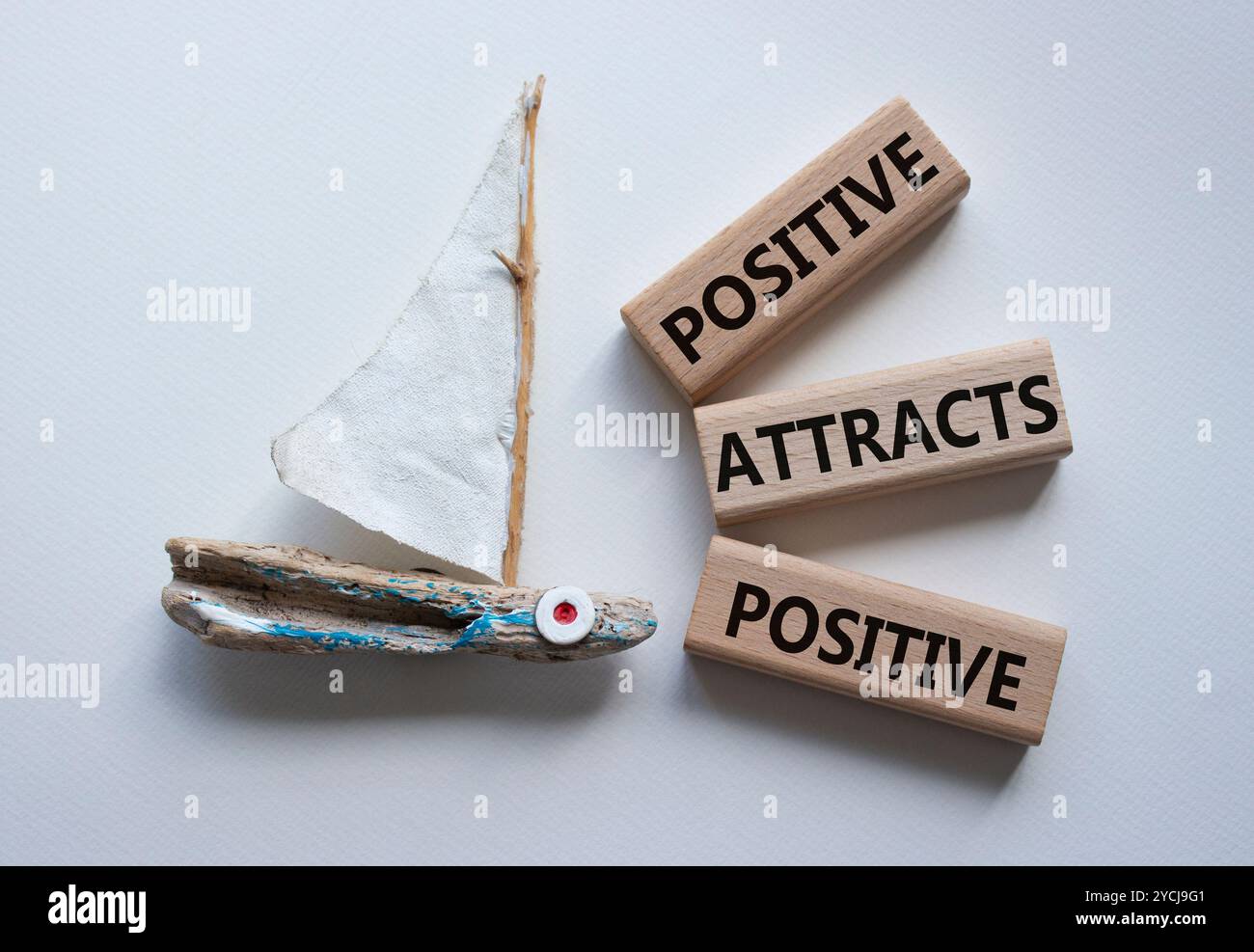 Positive attracts Positive symbol. Wooden blocks with words Positive ...