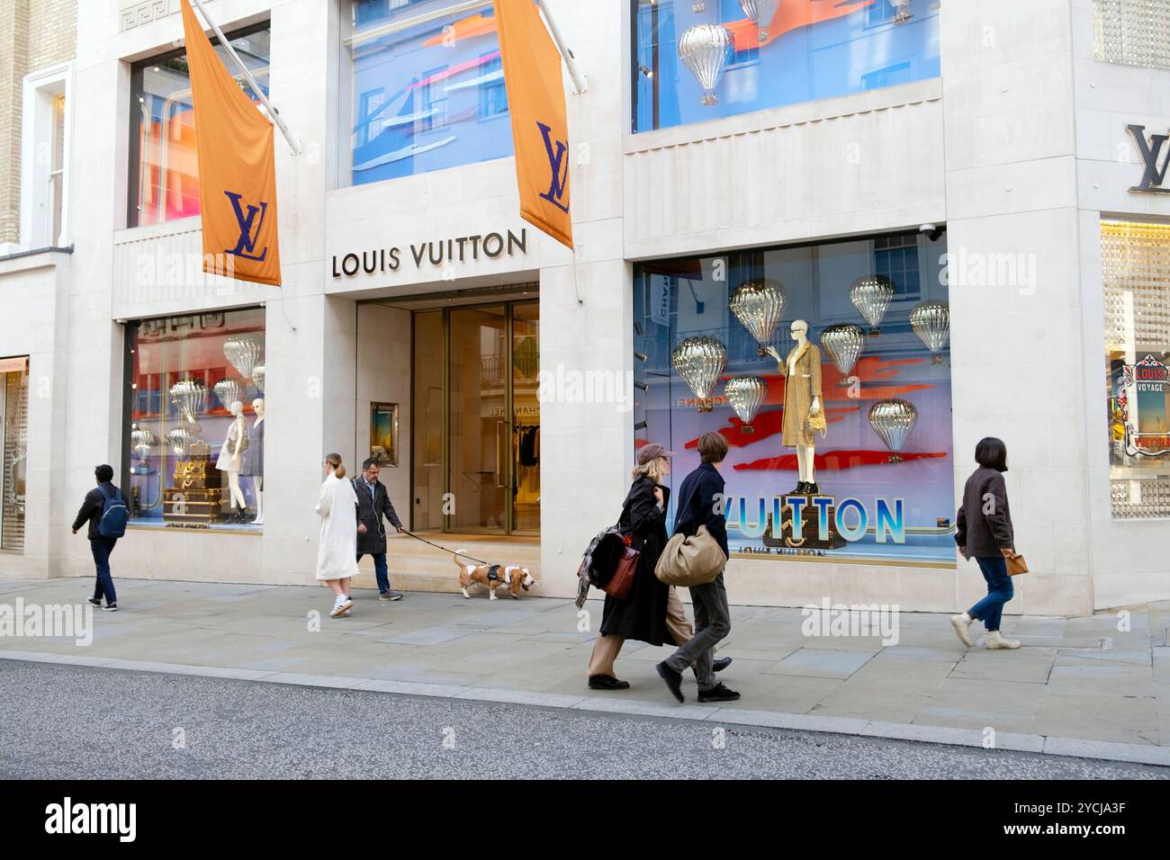 Exterior street view of shoppers people outside Louis Vuitton store ...