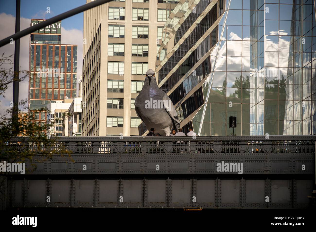 Workers finish up installation of “Dinosaur” (2024) by the artist Iván ...